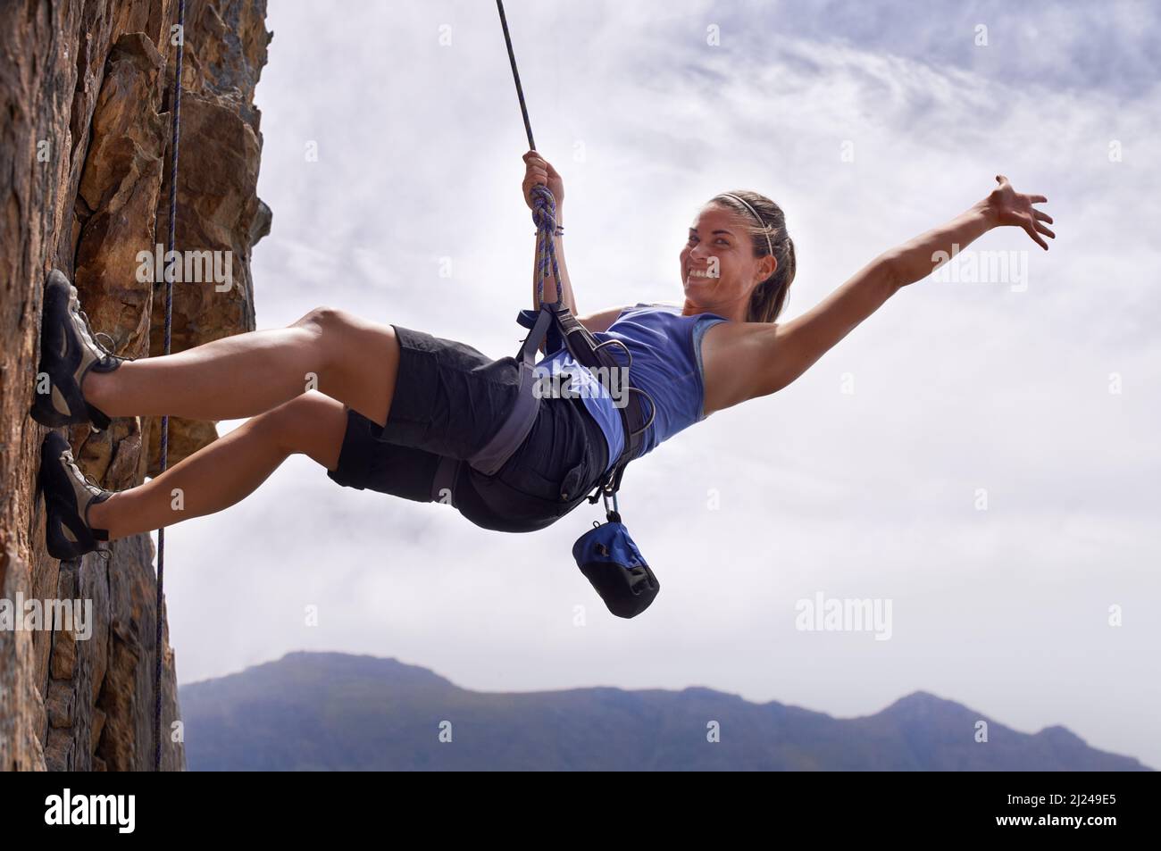 Nothing gets the heart going like scaling a rock face. Shot of a young ...