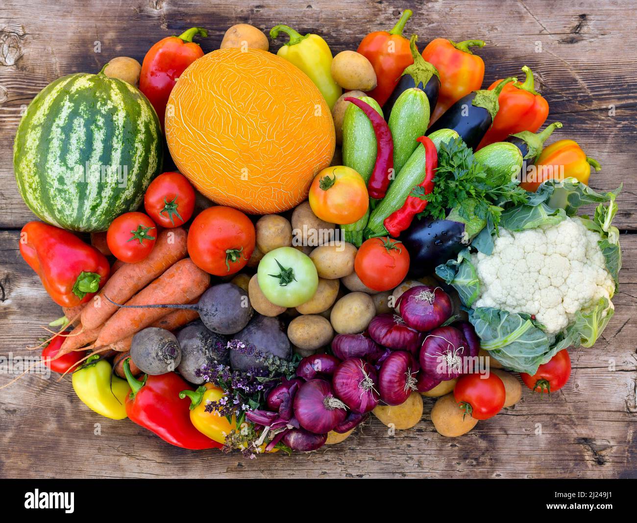 A bunch of colorful vegetables on a wooden surface Stock Photo - Alamy