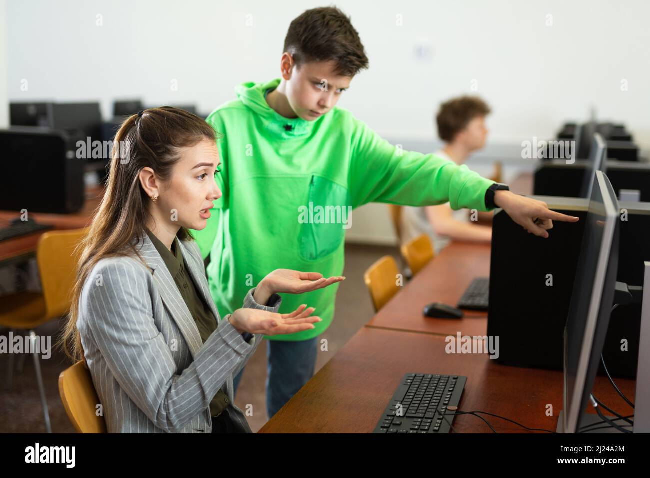 Teacher shows the student how to solve the problem on computer Stock ...