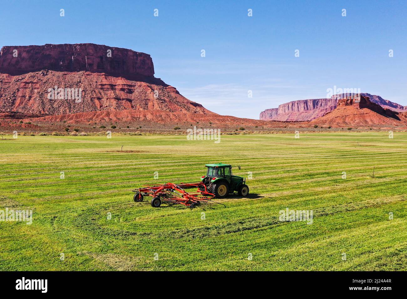 Rotary rake behind a tractor on a scenic ranch Stock Photo - Alamy
