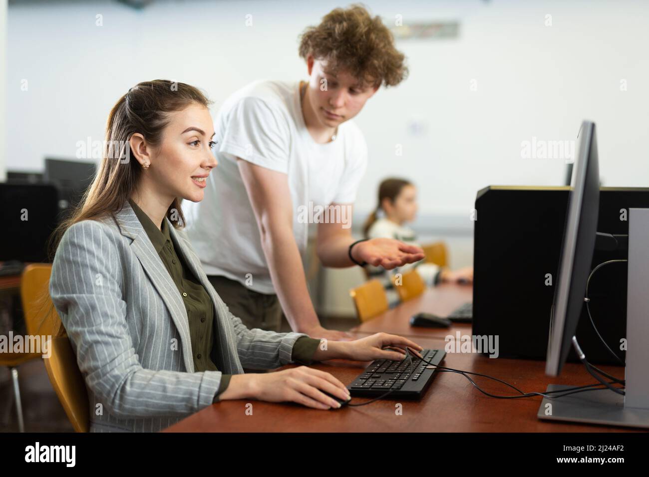 Teacher shows the student how to solve the problem on computer Stock ...