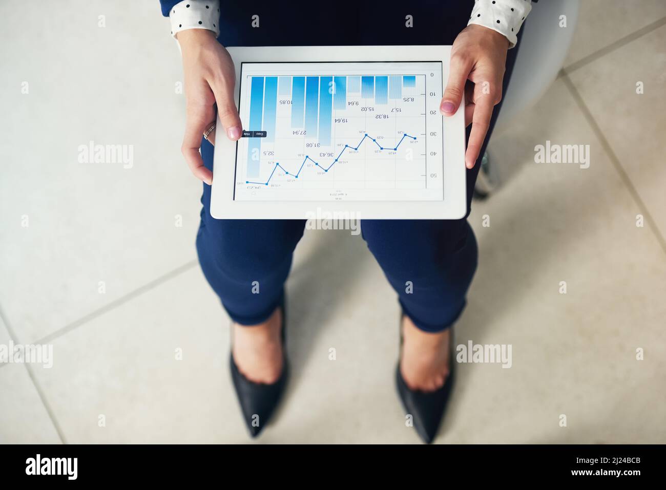 Graphs can tell a story. High angle shot of an unrecognisable ...