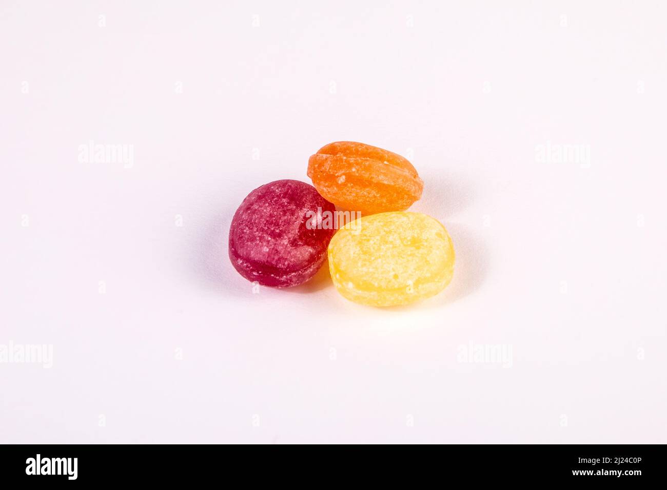 Colored stack of candies on a white background. Lollipops and sweets ...