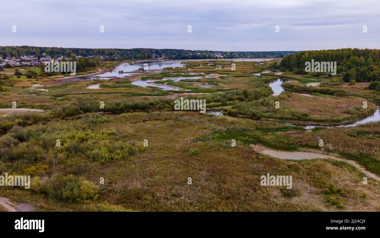 perspective aerial view of swamp and lake near village in Kirov Region ...