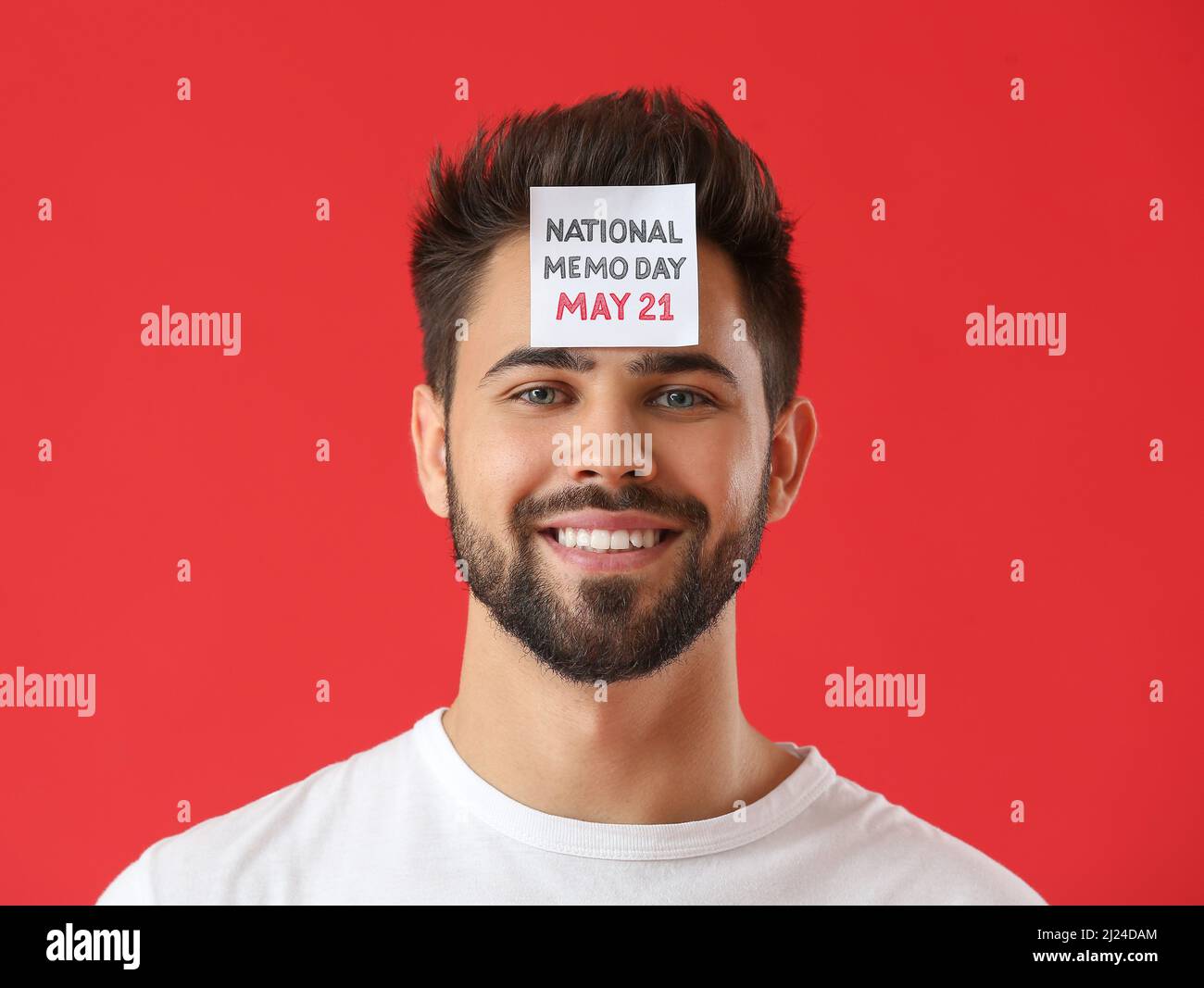 Paper with text NATIONAL MEMO DAY. MAY 21 on forehead of young man ...