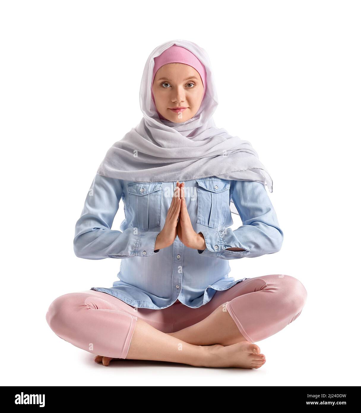 Pregnant Muslim woman meditating on white background Stock Photo - Alamy