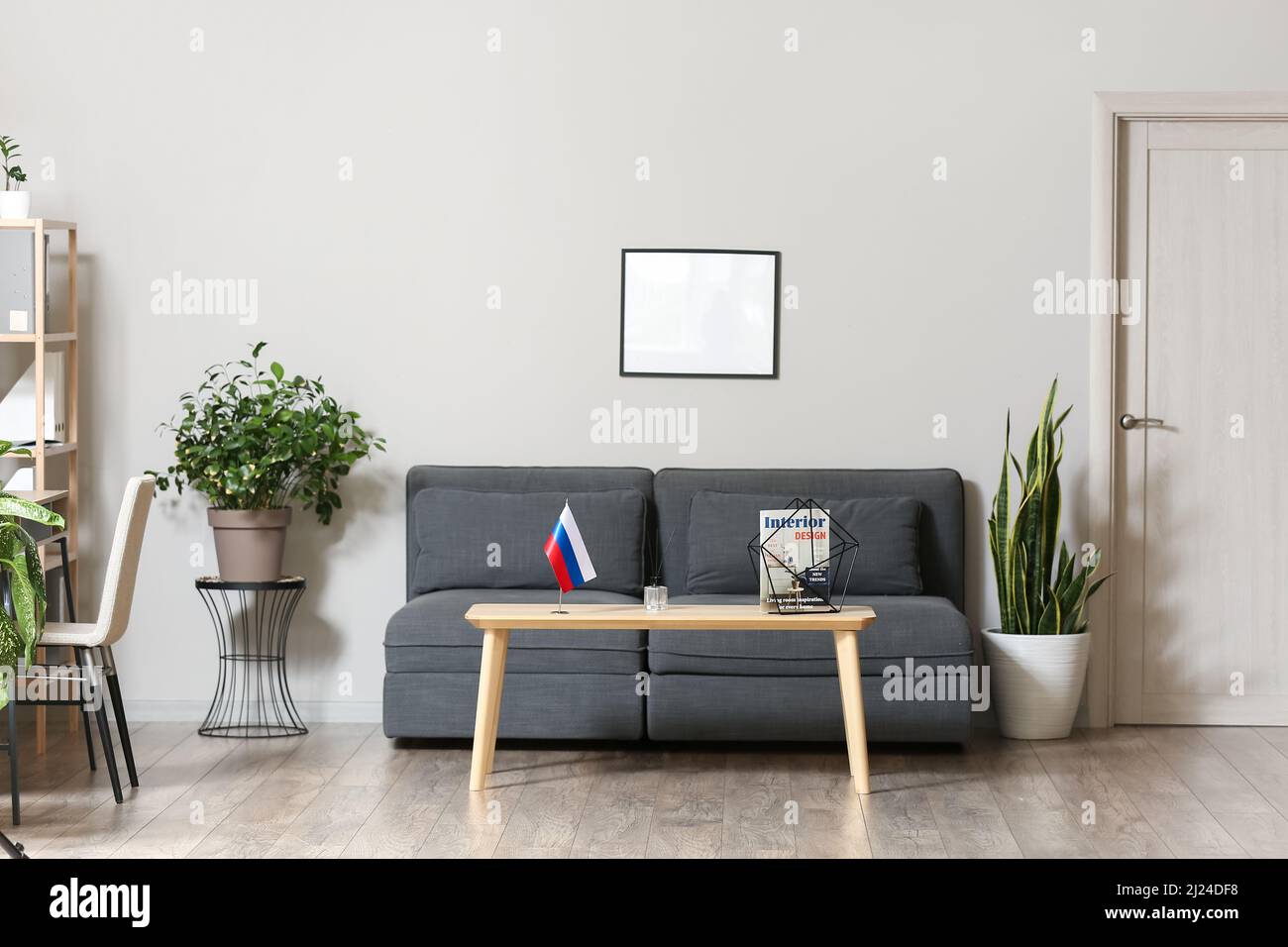 Interior of modern living room with Russian flag on table Stock Photo ...