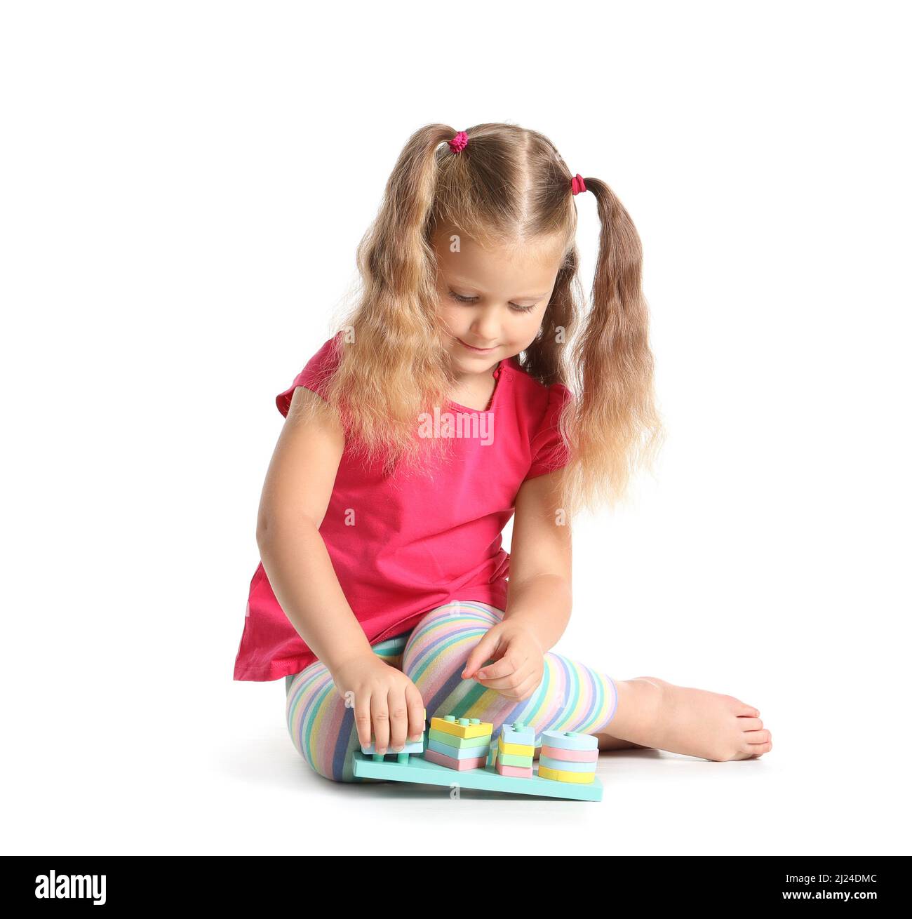 Adorable little girl playing with building blocks on white background ...