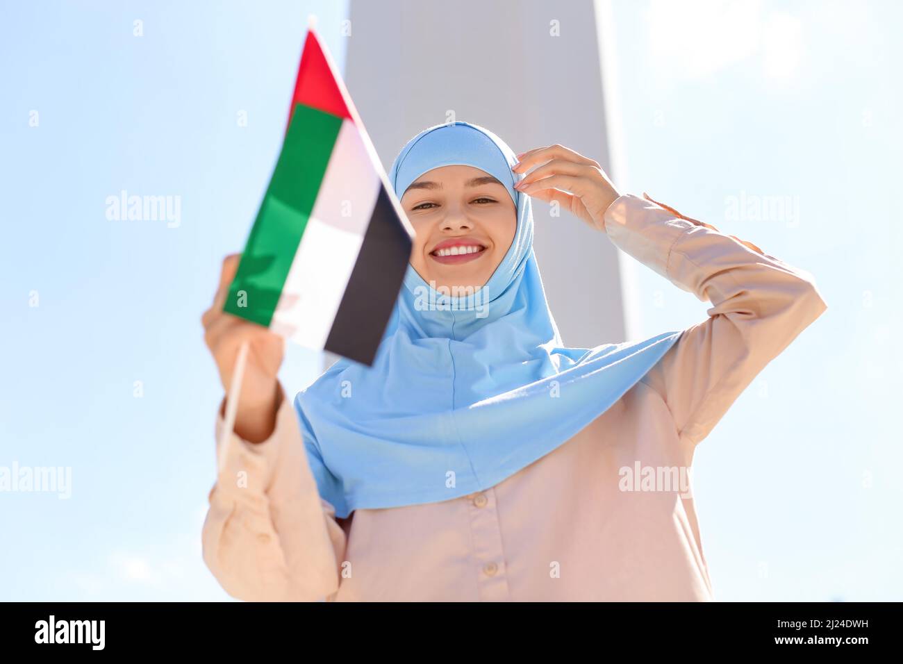 Beautiful Muslim woman with UAE flag outdoors Stock Photo - Alamy