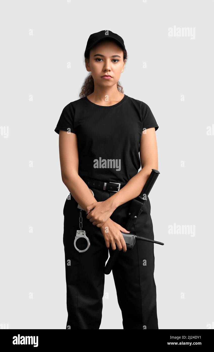 African-American female security guard with radio transmitter on light ...