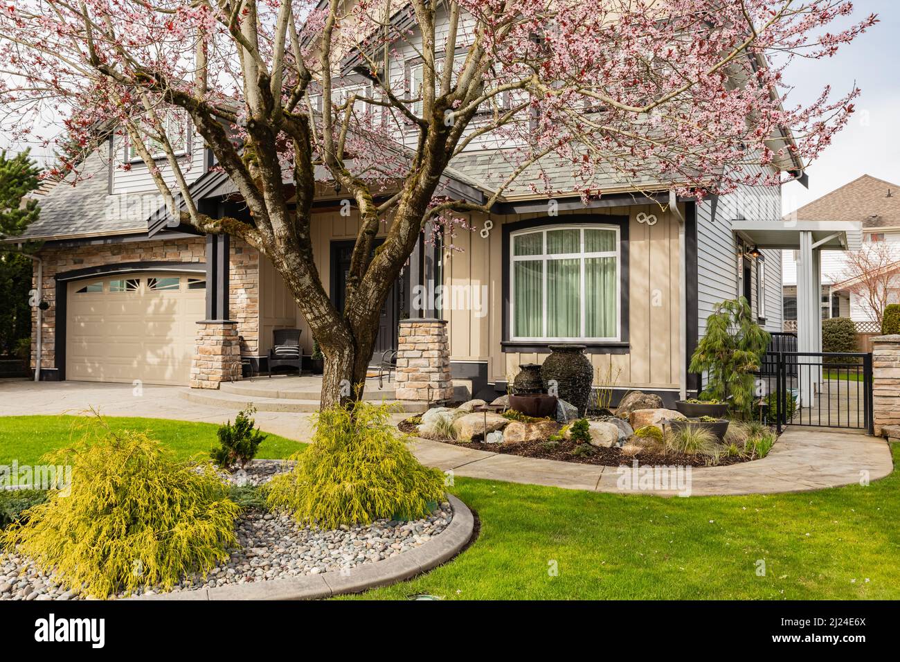 Neighborhood modern houses building with spring flowers in patio in BC ...