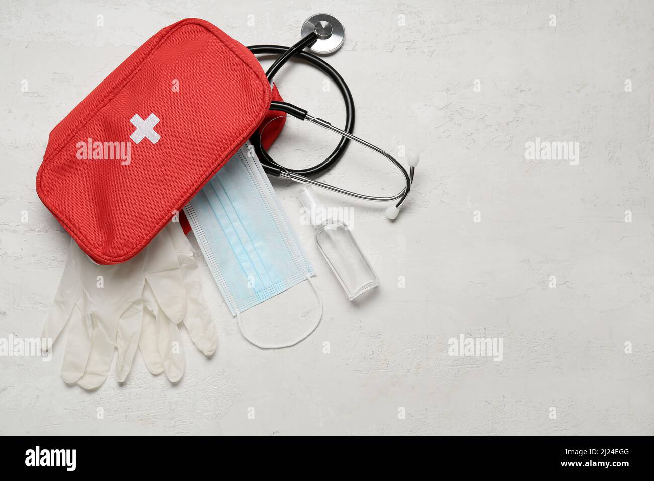 First aid kit, stethoscope, medical mask, gloves and antiseptic on ...