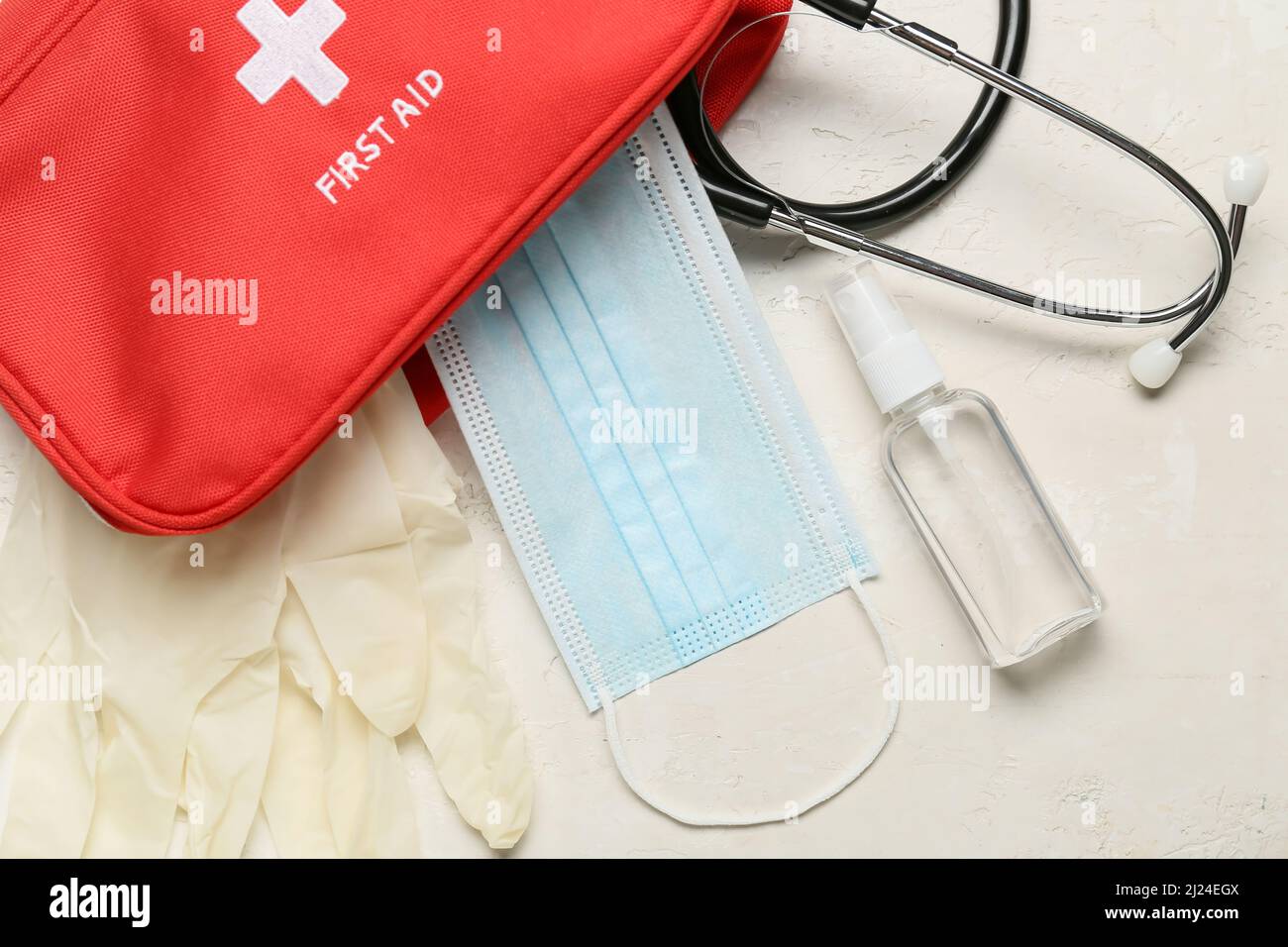First aid kit, stethoscope, medical mask, gloves and antiseptic on ...