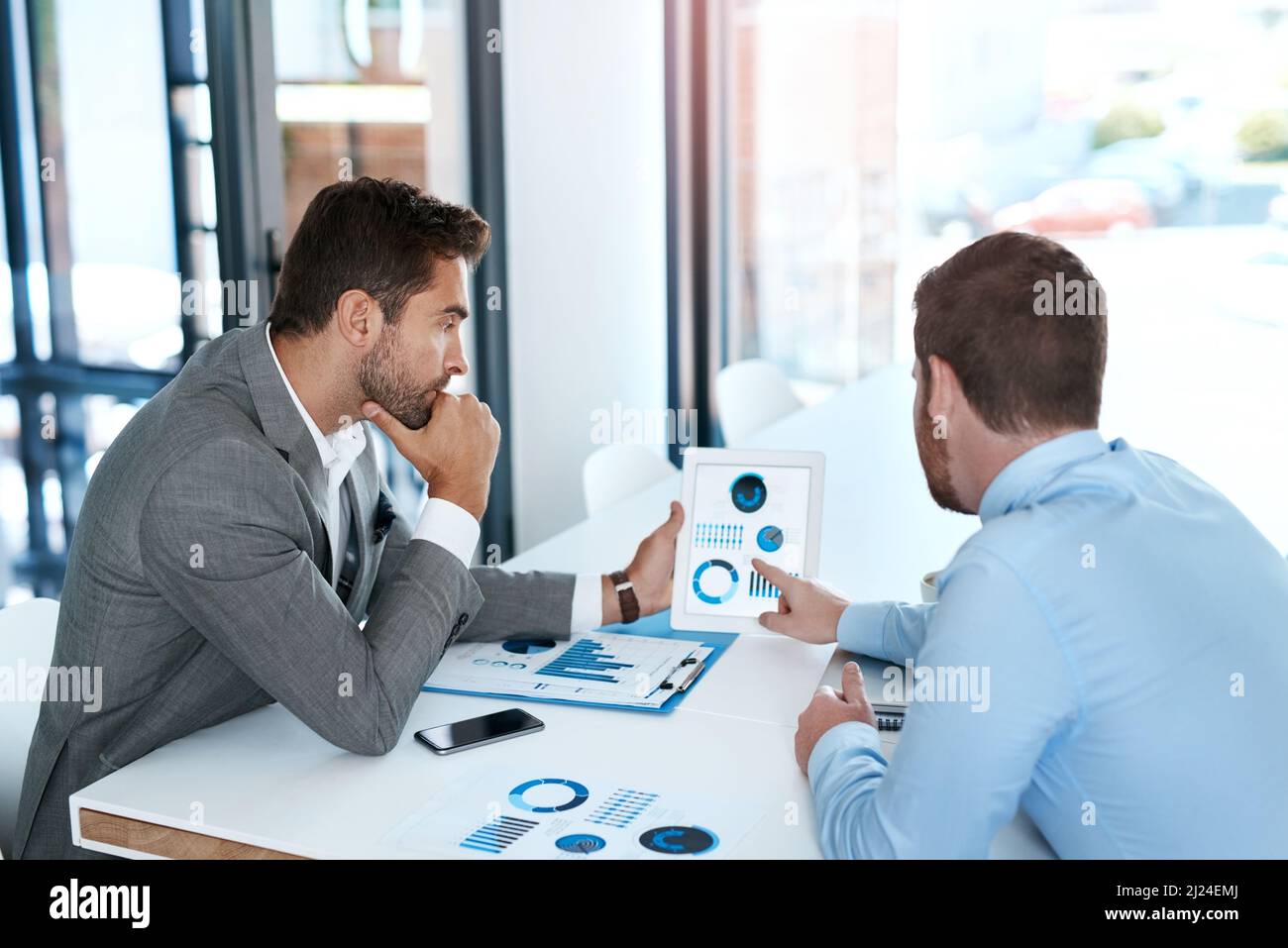 The numbers are hard to ignore. Cropped shot of two young businessmen ...