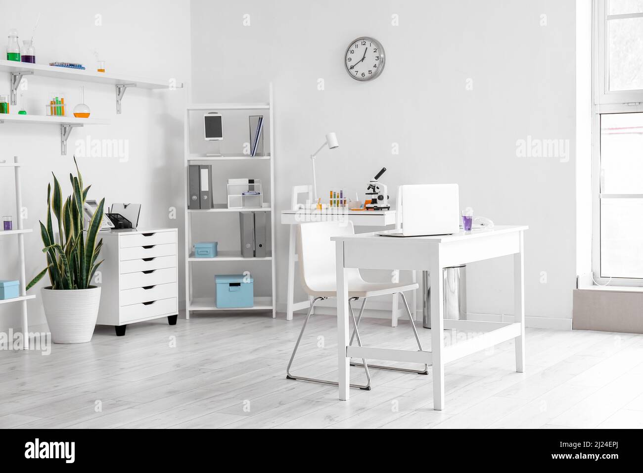 Interior of modern laboratory with workplace and chemical glassware ...