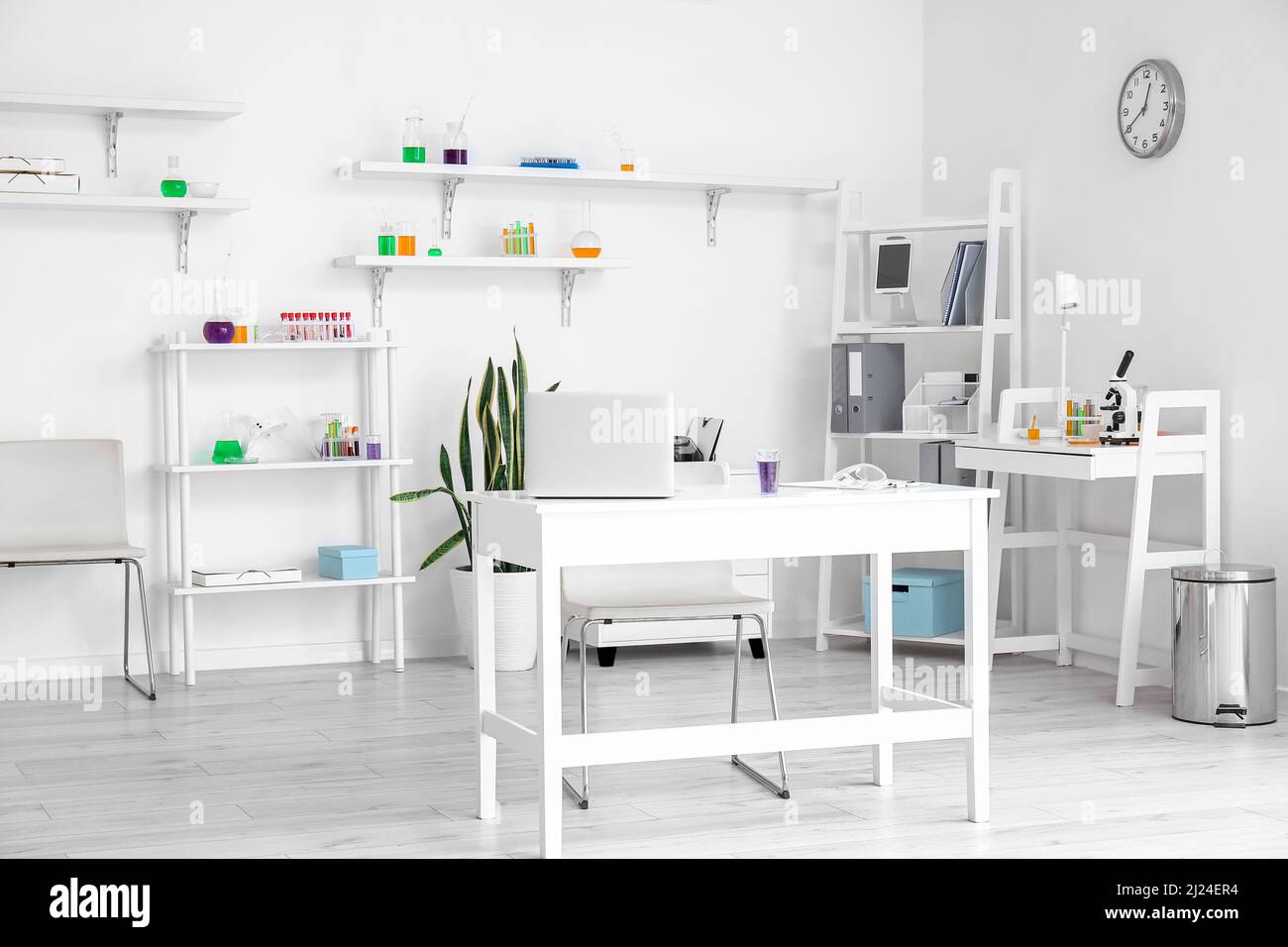 Interior of modern laboratory with workplace and chemical glassware ...