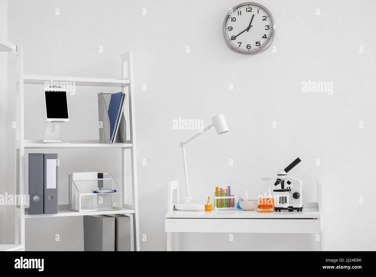 Interior of modern laboratory with table, chemical glassware and ...