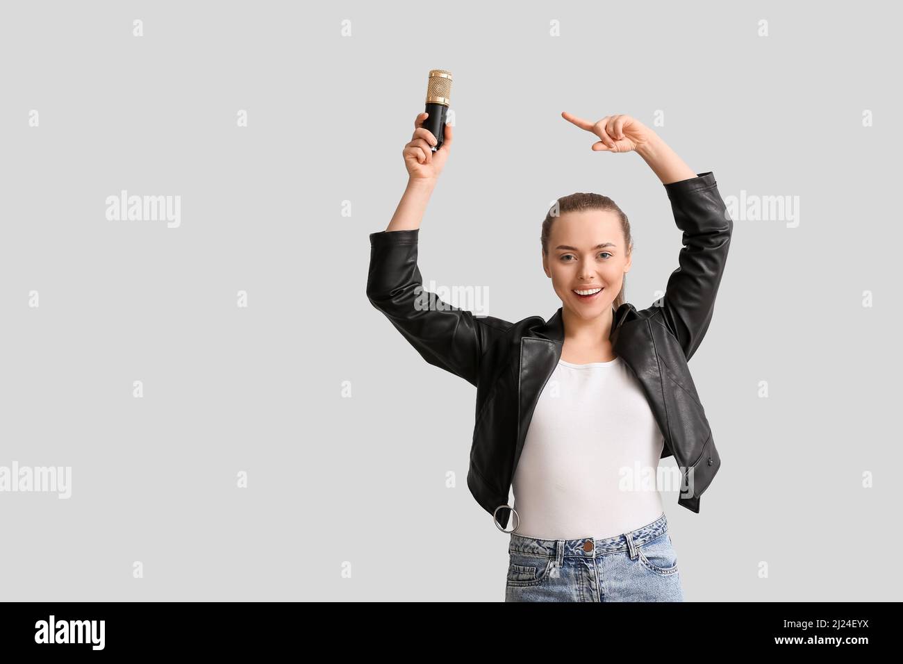 Female singer pointing to microphone hi-res stock photography and ...