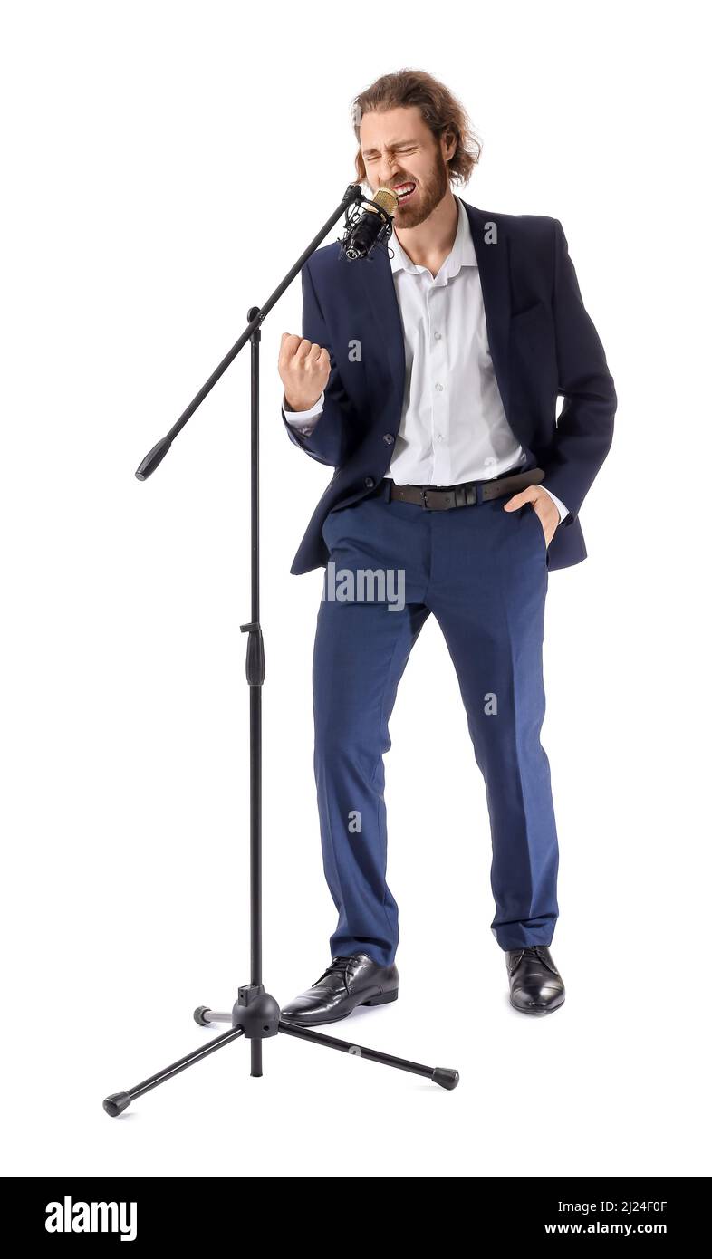 Handsome young man singing in microphone isolated on white Stock Photo ...