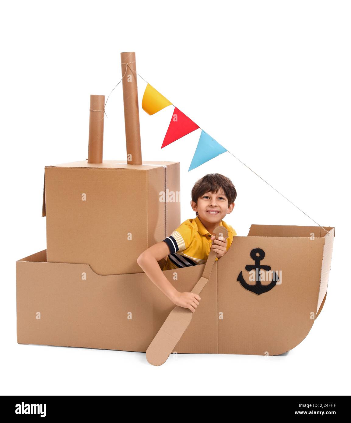 Cute little boy playing with cardboard ship on white background Stock ...