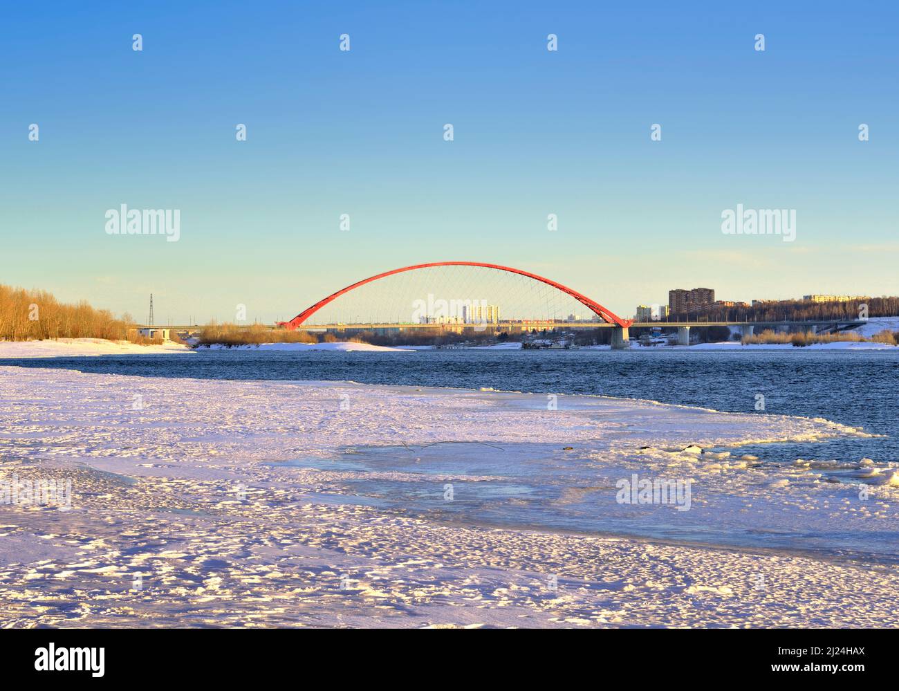 Arch bridge on the Ob River. Bugrinsky bridge on the snowy shore in the ...