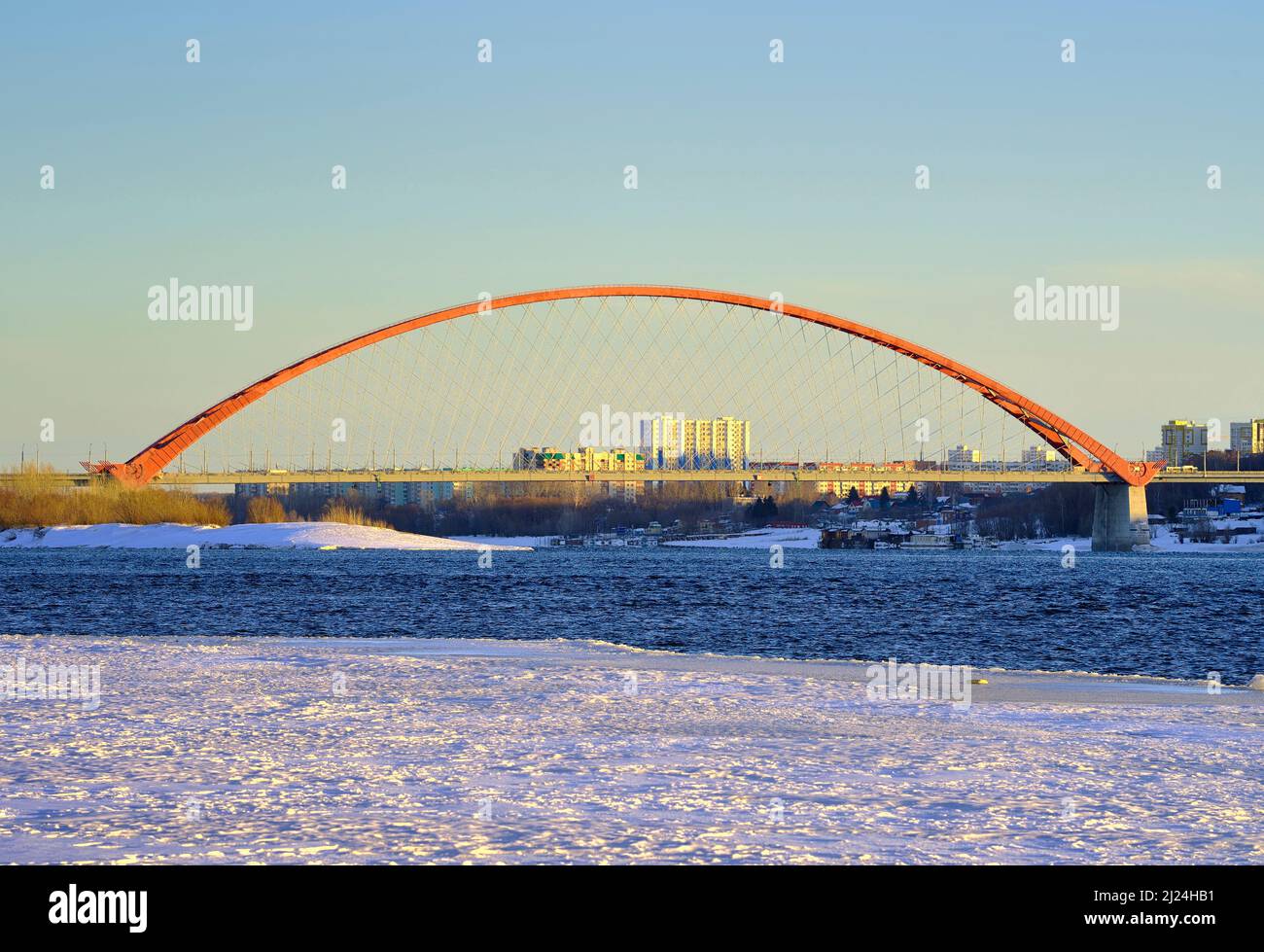 Arch bridge on the Ob River. Bugrinsky bridge on the snowy shore in the ...