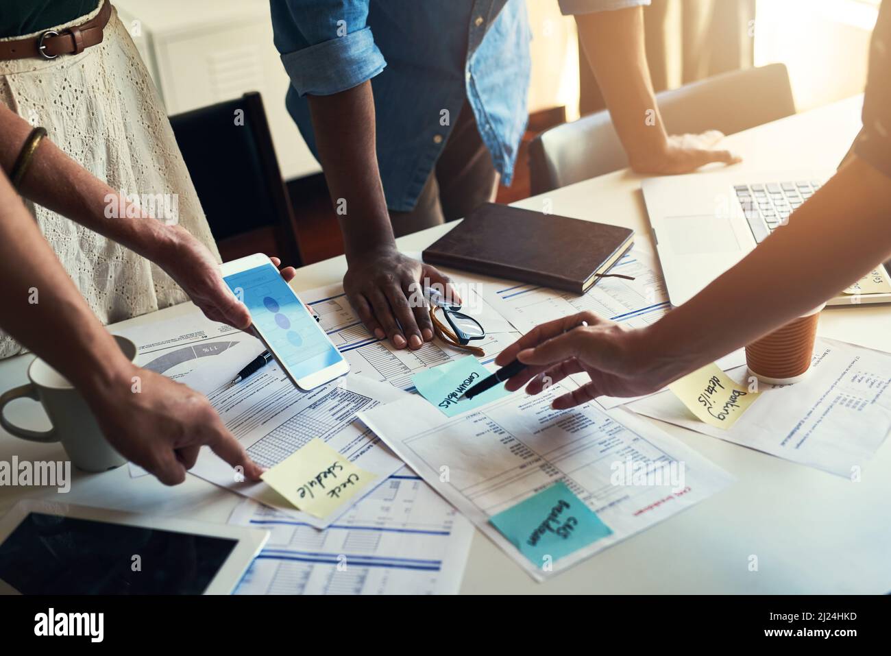 Around the meeting table. High angle shot of a group of unrecognizable ...