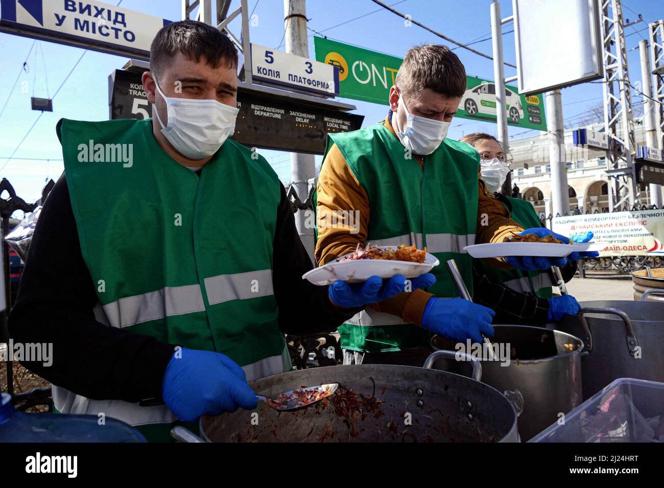 Volunteers provide free hot meals for internally displaced persons at ...