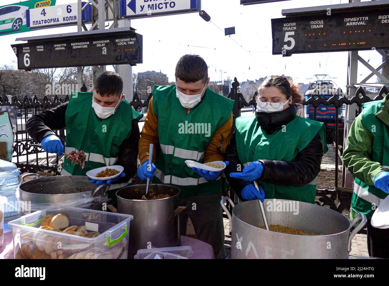 Volunteers provide free hot meals for internally displaced persons at ...