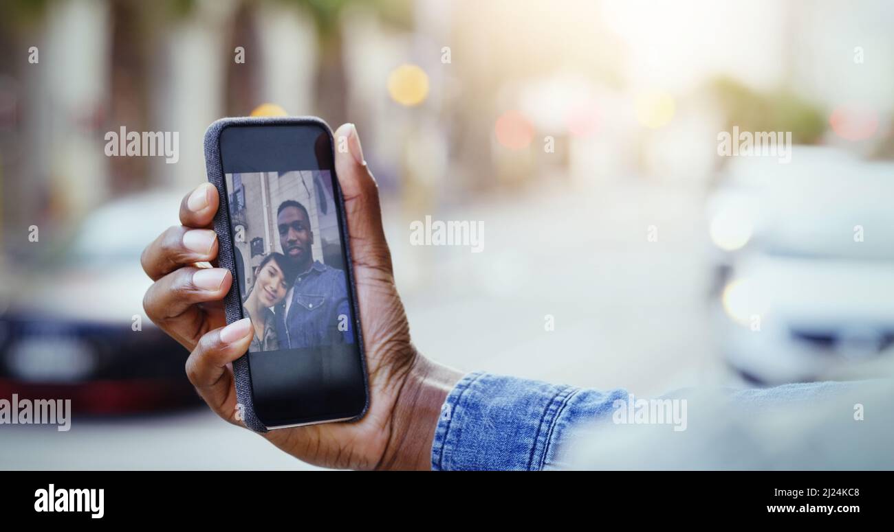 Real life pictures. Shot of a young couple taking a selfie together ...