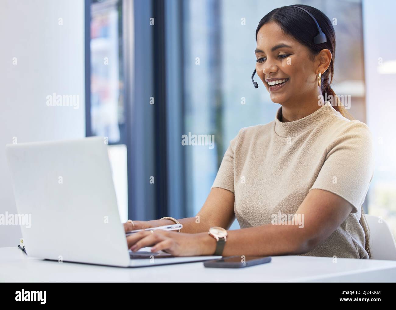 Customers love her friendly manner. Shot of a young businesswoman ...