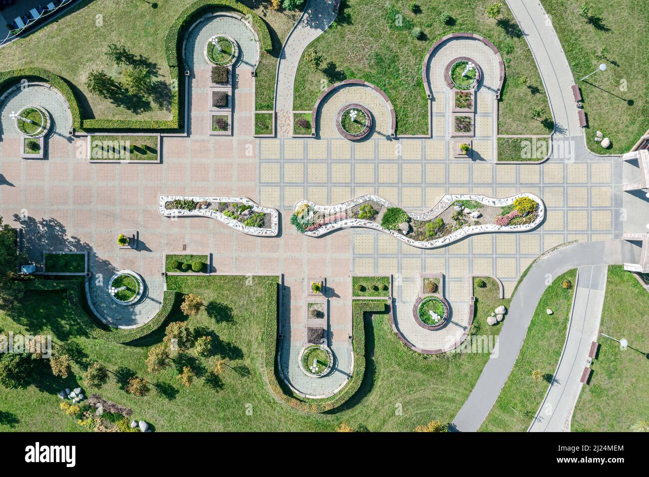 recreation place with footpaths, green lawn and trees. summer park ...