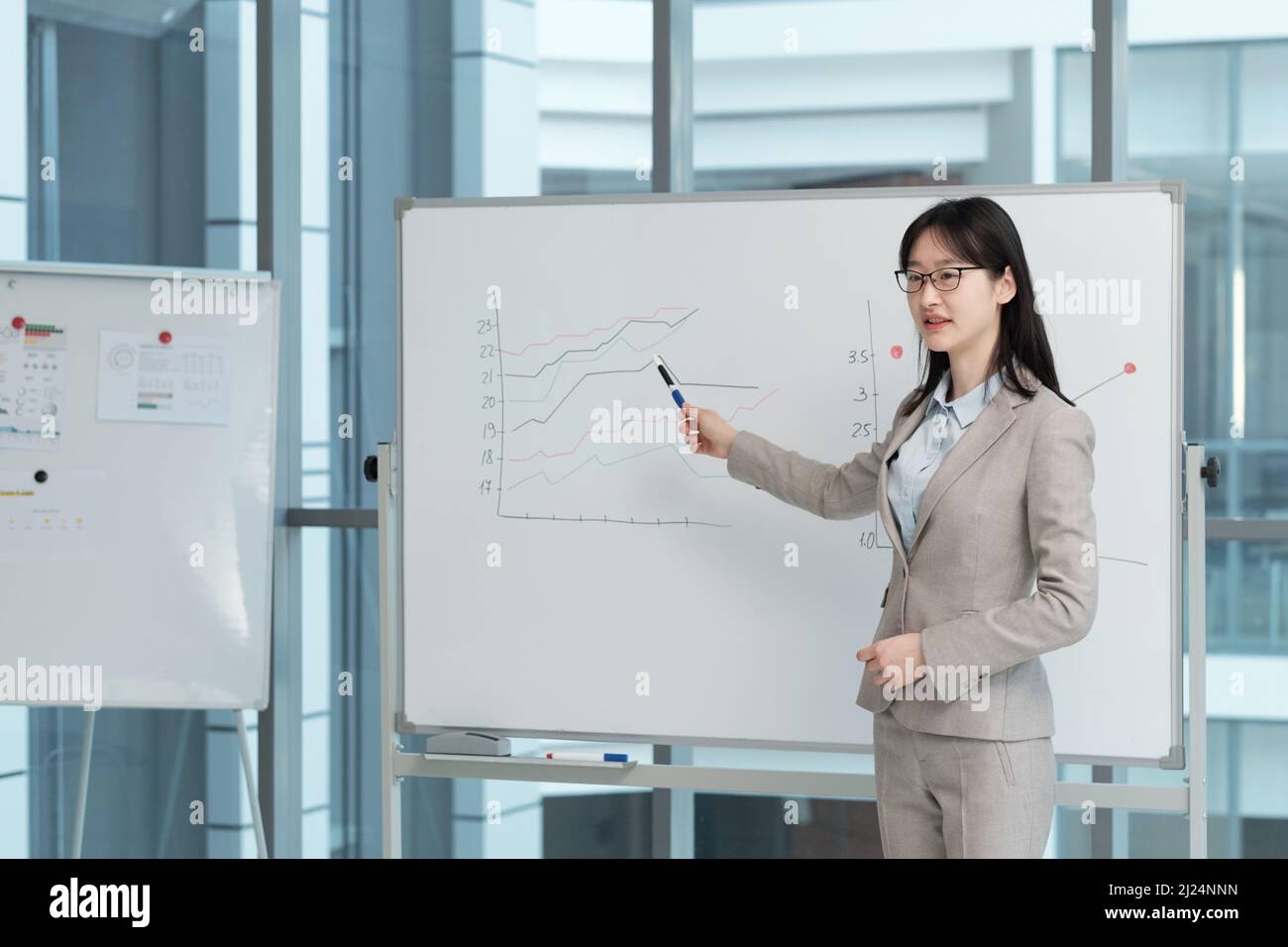 Female teacher pointing whiteboard during hi-res stock photography and ...