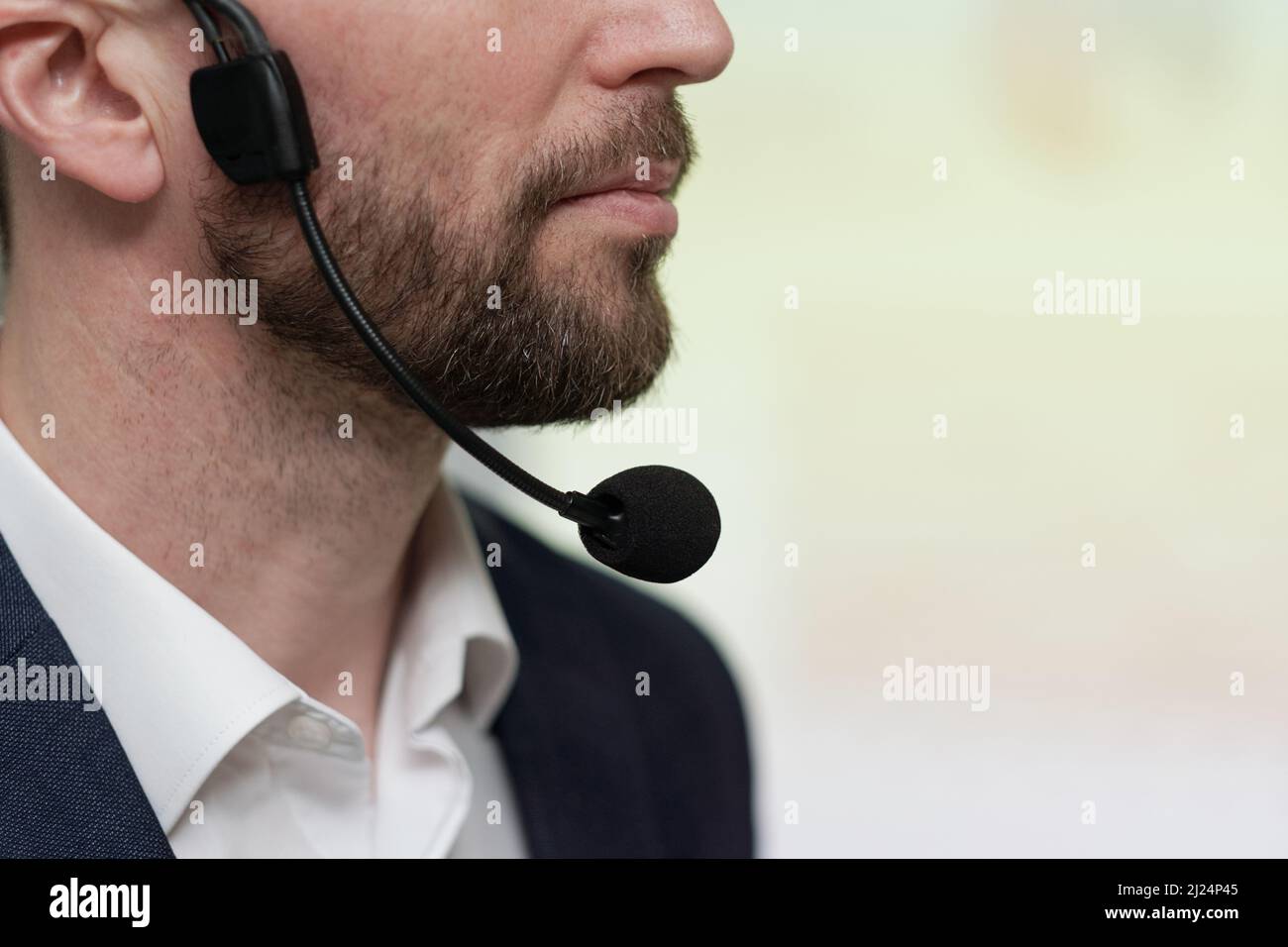 Close-up of lower part of face of young serious businessman with ...