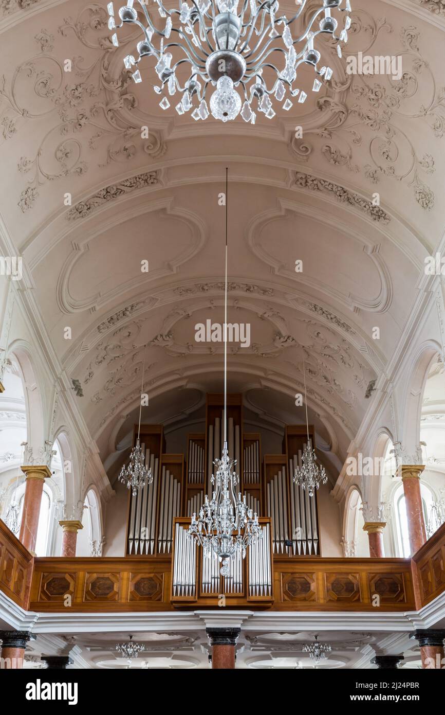 symmetric view on organ pipe and chandelier of St. Peter church in ...