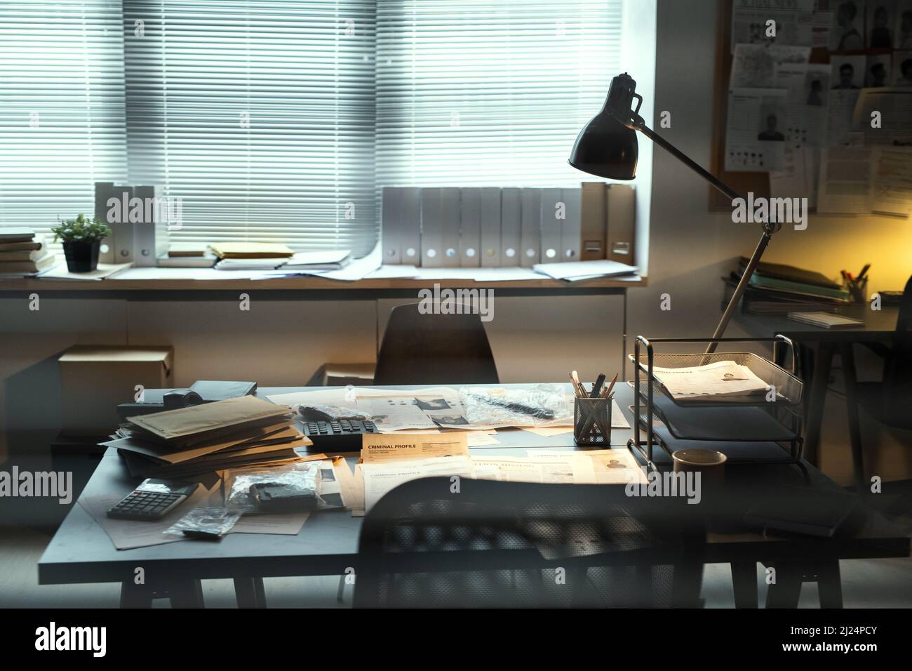 Lamp lighting workplace of contemporary FBI agent with criminal ...