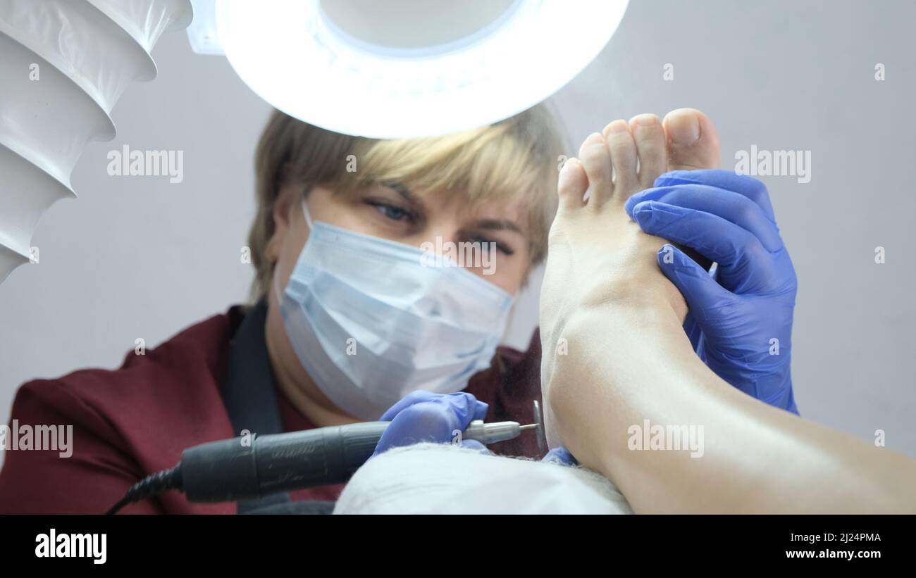 Patient on medical pedicure procedure, visiting podiatrist.Professional ...