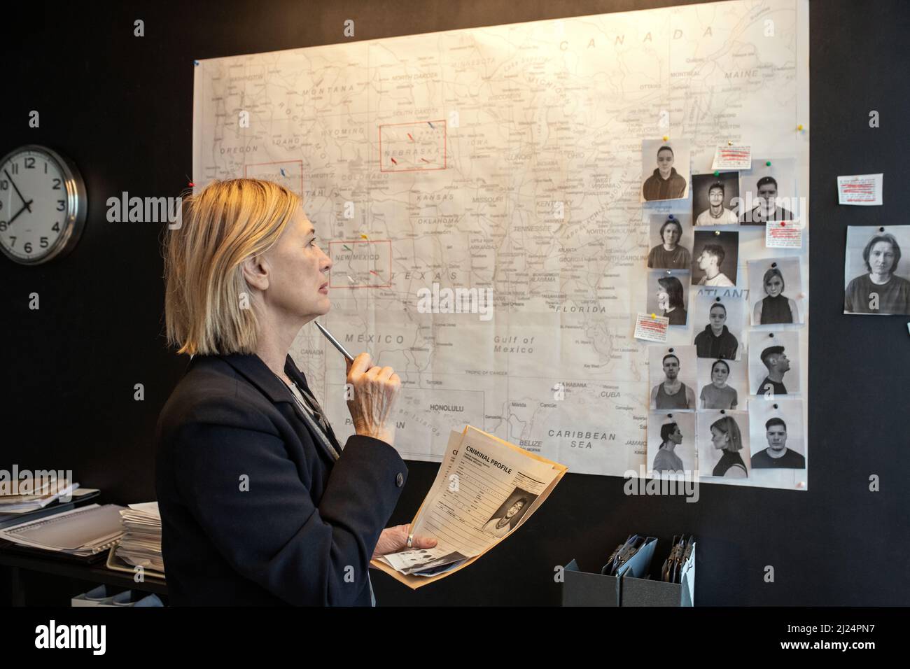 Mature female agent of FBI with documents matching facts of crime ...