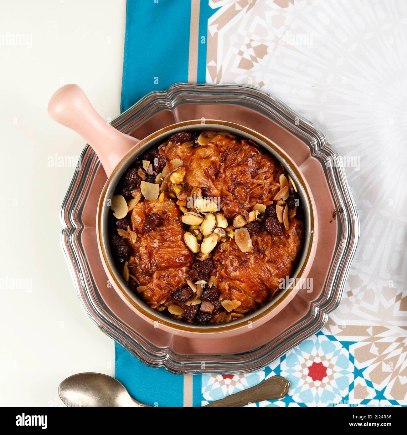 Um Ali dessert with chopped nuts and raisins. Egyptian bread pudding on ...
