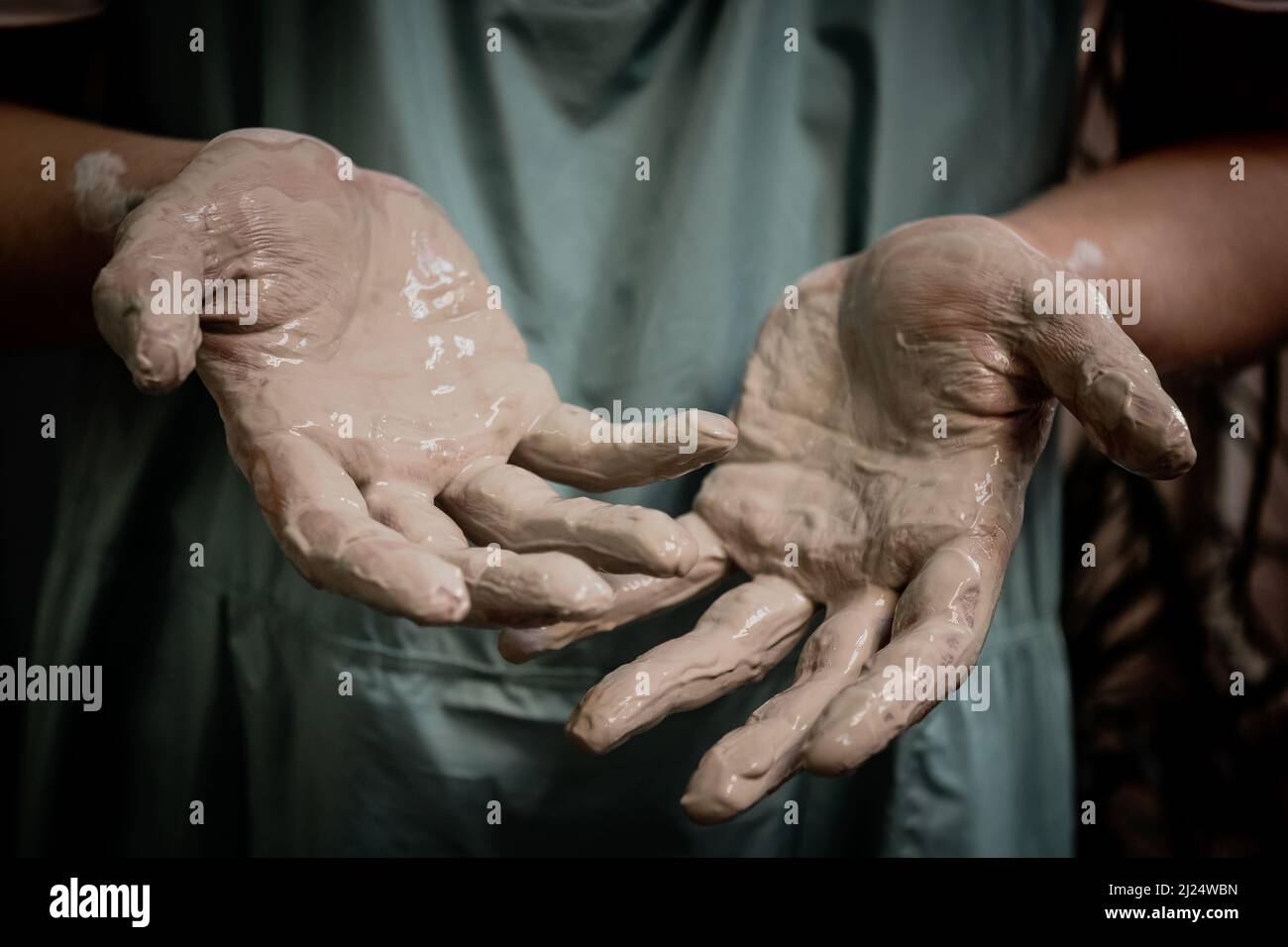 Hands in clay after working at the potter's wheel, close-up Stock Photo ...