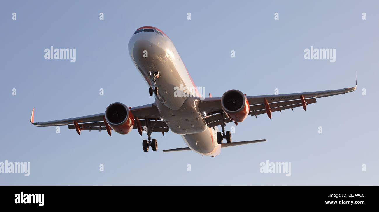 Large airplane preparing the landing with a blue sky Stock Photo - Alamy