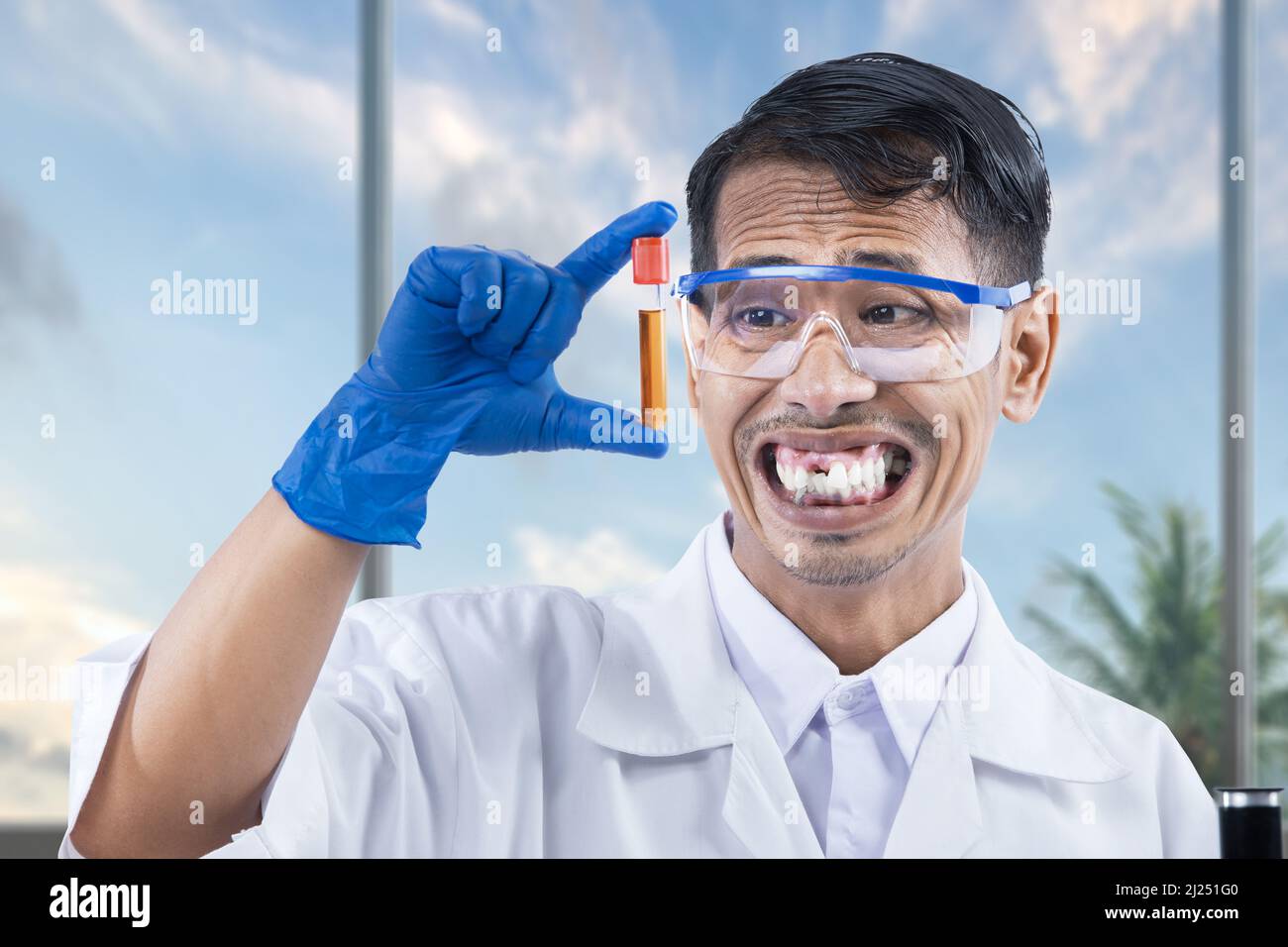 Asian nerd scientist holding a sample tube in the laboratory Stock ...