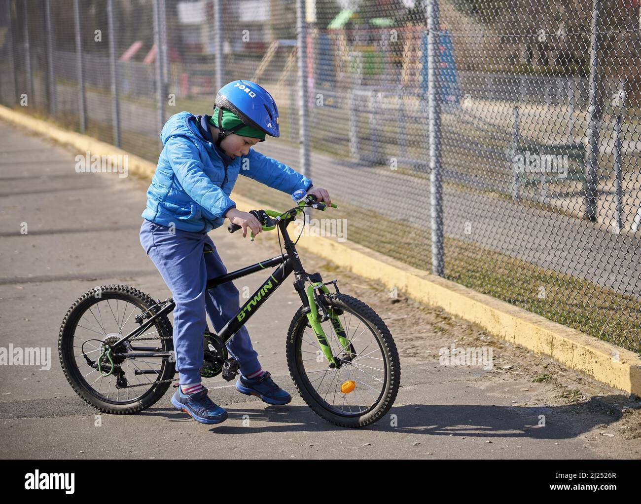 A young boy with a safety helmet standing on his bicycle in the Stare ...