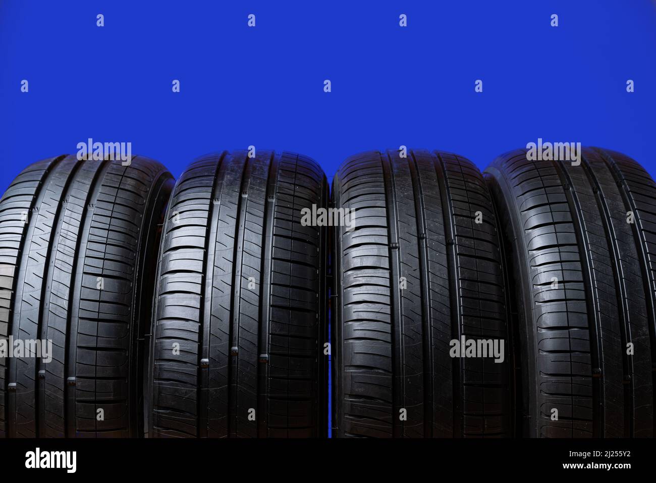 Group of tires on a blue background Stock Photo - Alamy