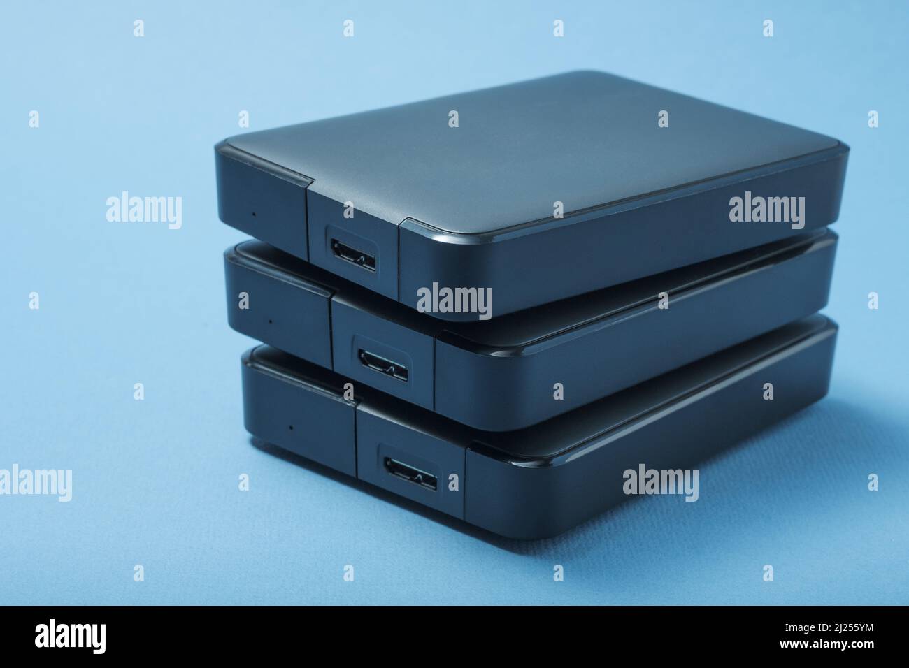 A stack of hard drives on a blue background Stock Photo - Alamy
