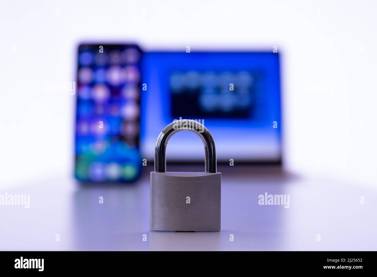 Privacy and data protection: Laptop and smartphone with locked padlock ...