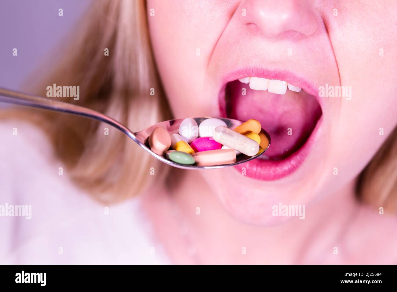 Blonde girl taking a pills, medicine, drugs Stock Photo - Alamy