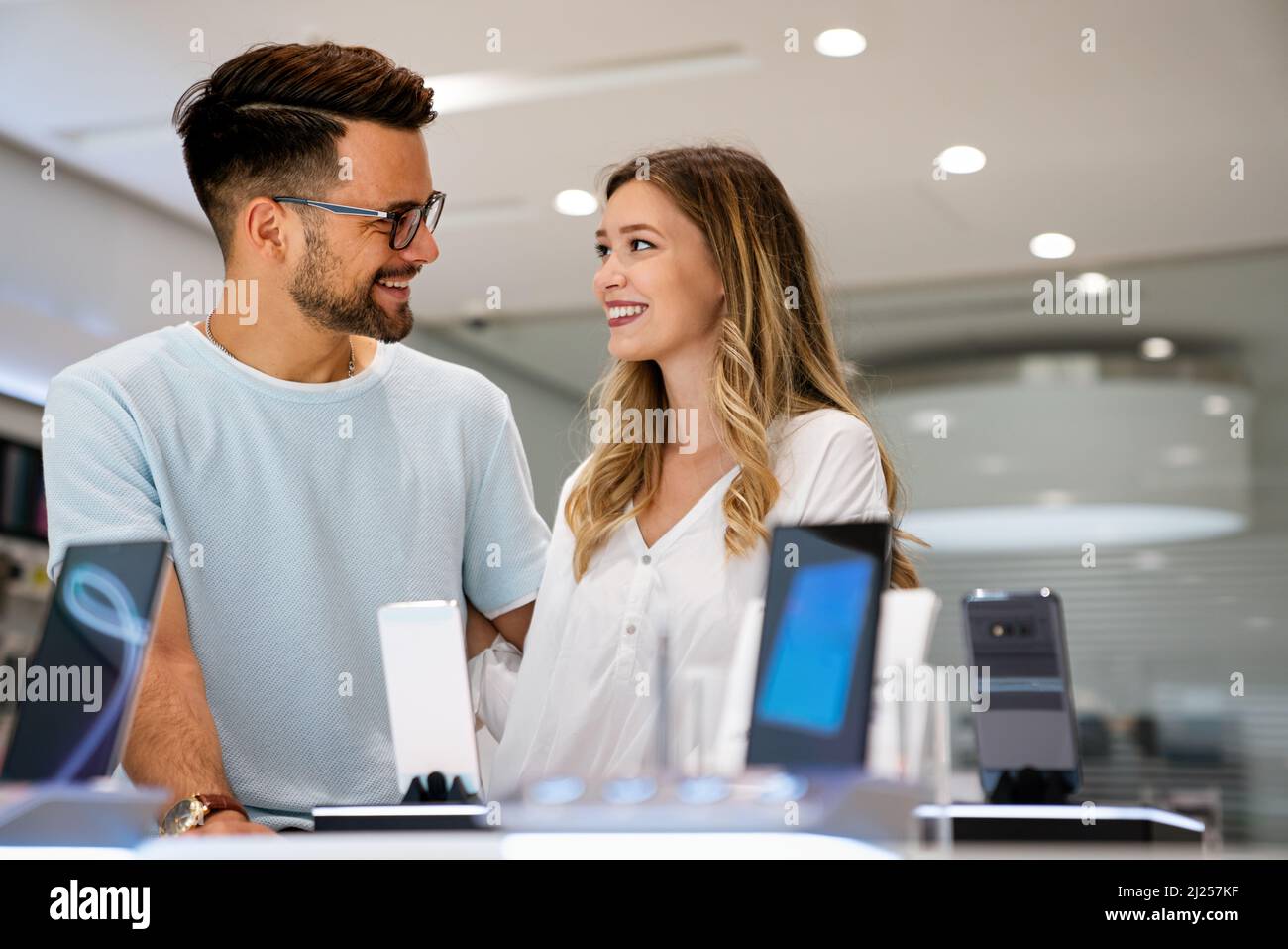 Tech shopping device gadget concept. Happy young people buying a new ...