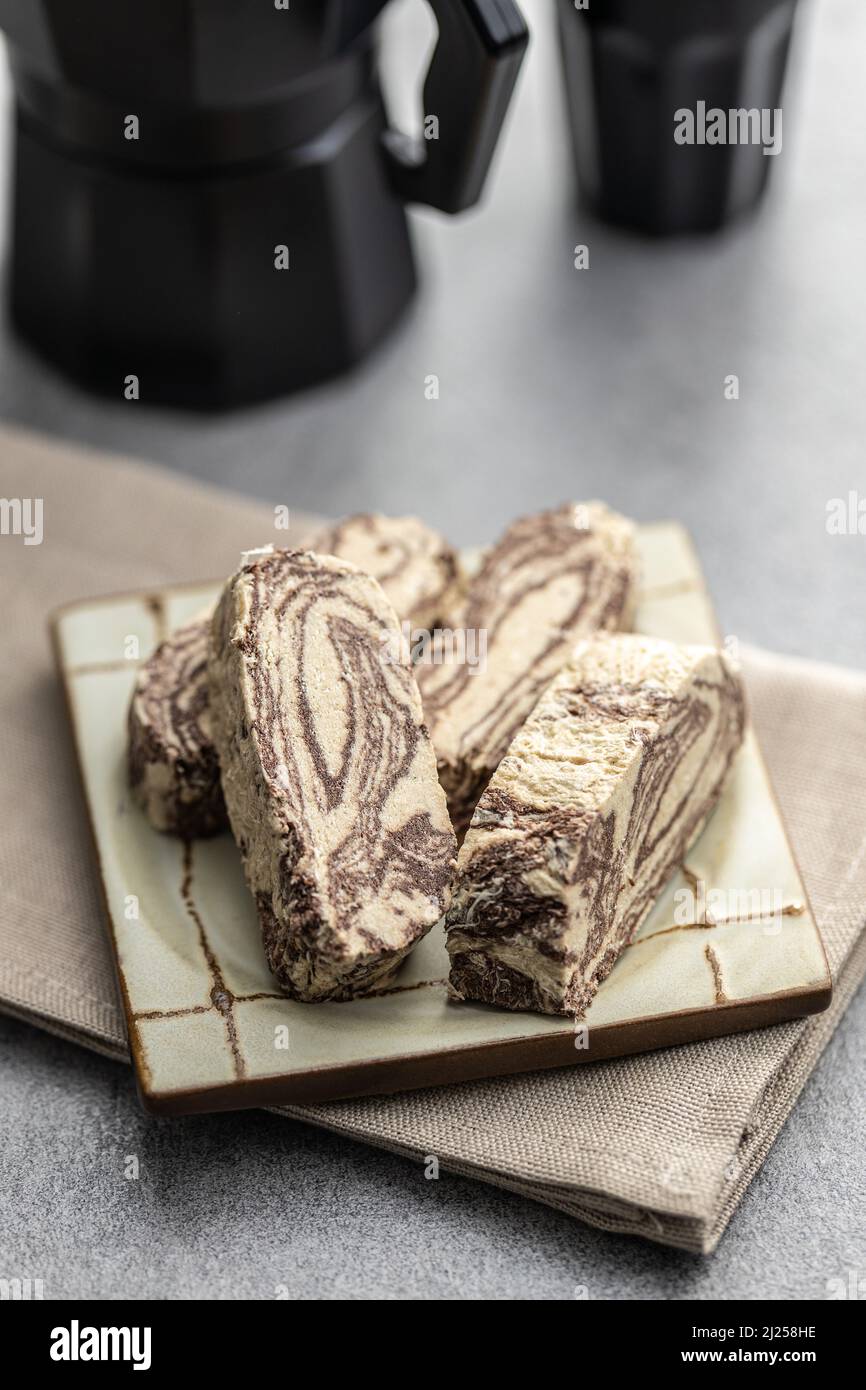 Sweet tahini halva with cocoa flavor. Turkish dessert on a plate Stock ...