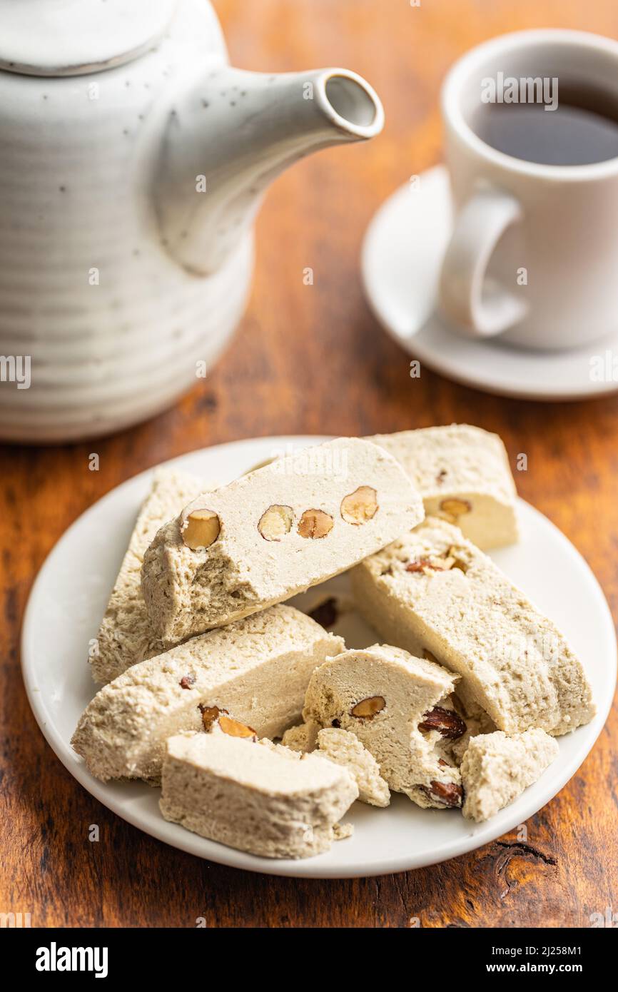 Sweet tahini halva with almonds. Turkish dessert on a plate Stock Photo ...